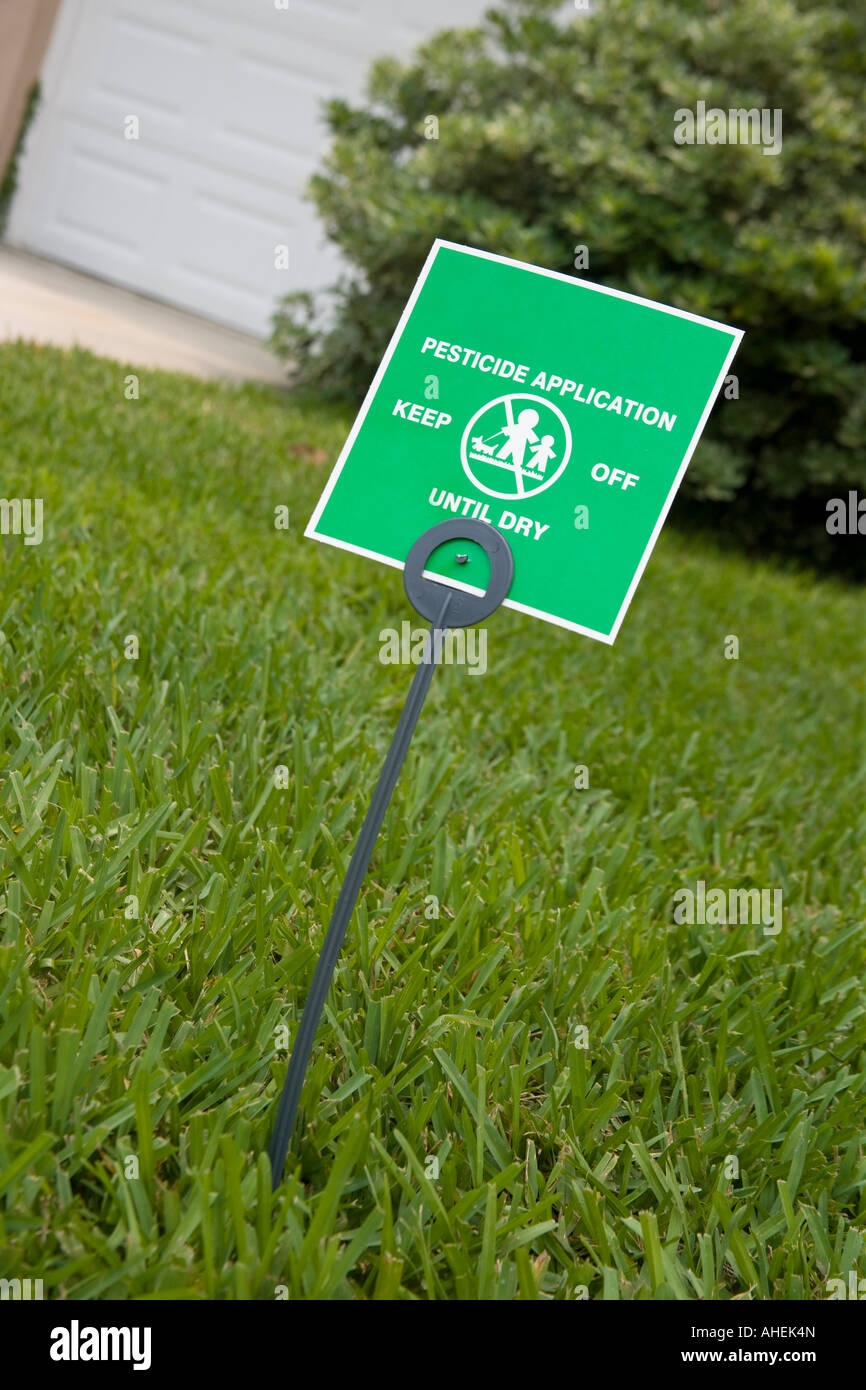 Pesticide application sign on home lawn Stock Photo - Alamy