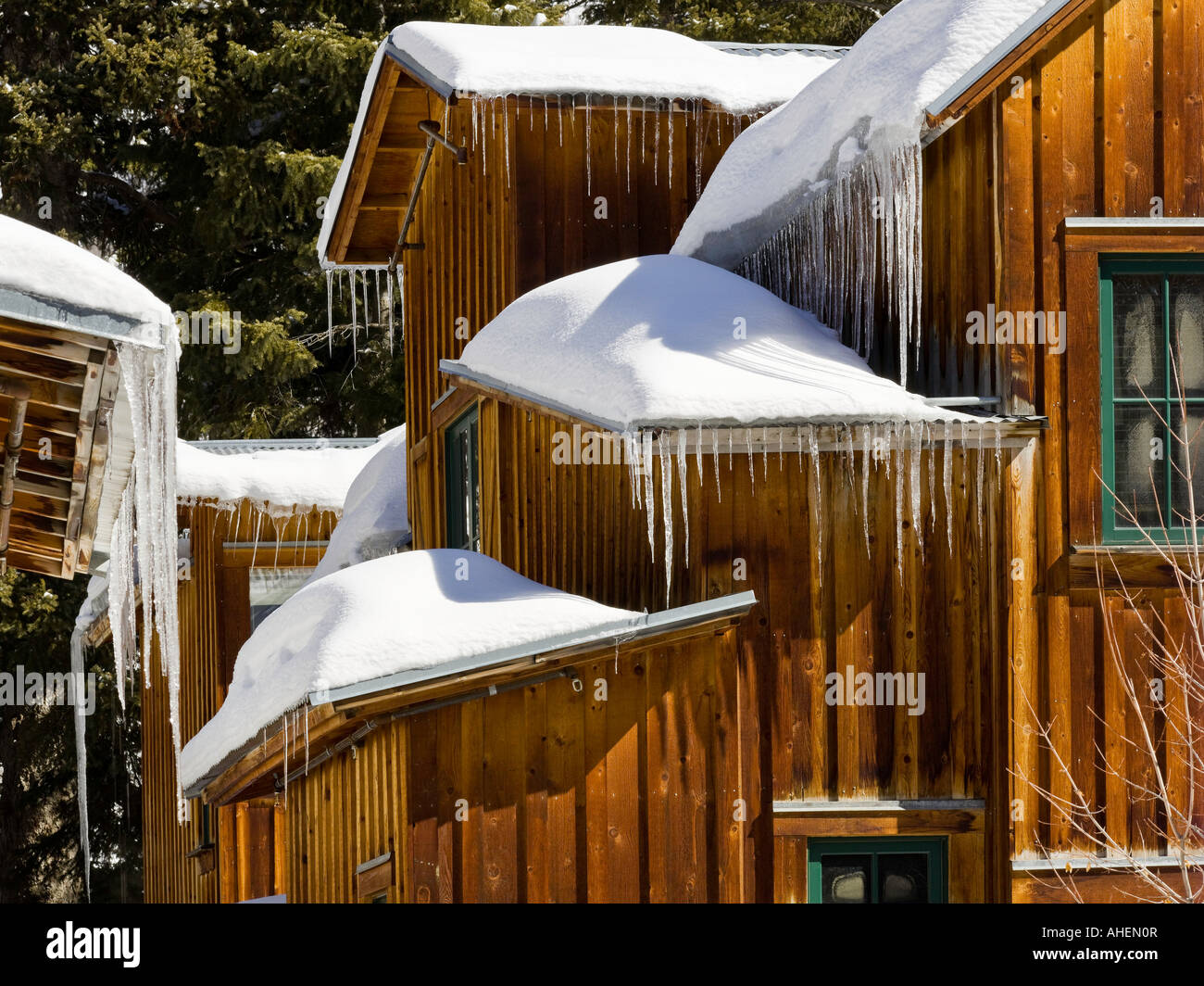Snow and ice covered wood cabin Stock Photo - Alamy