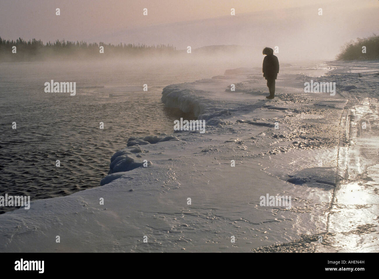 Man bundled in heavy clothing stands by edge of ice in minus 20 ...