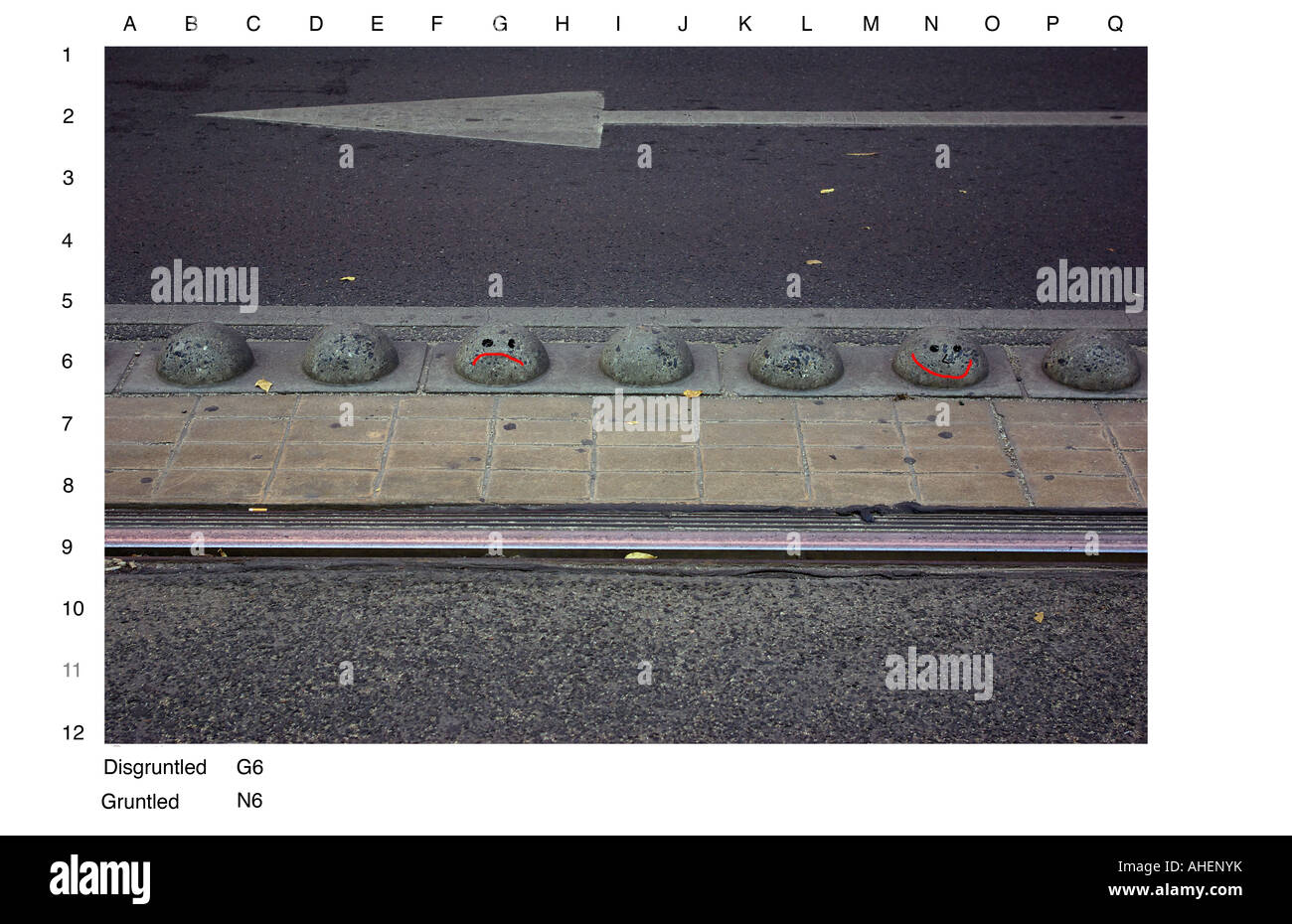 A night photo of a train track speed bumps and white traffic arrow ...