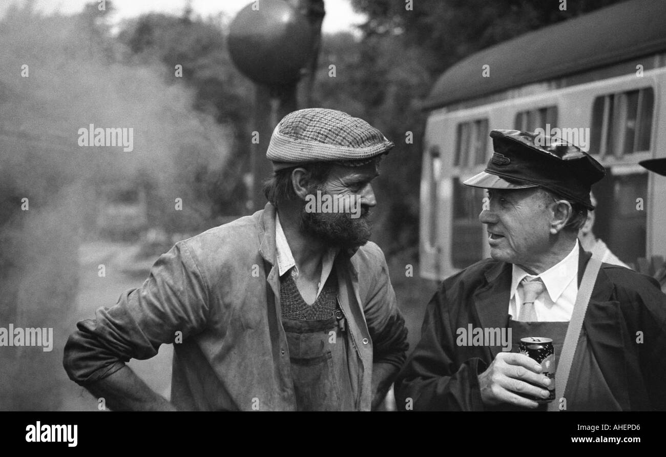 Steam engine driver talking to guard at preserved railway line at ...