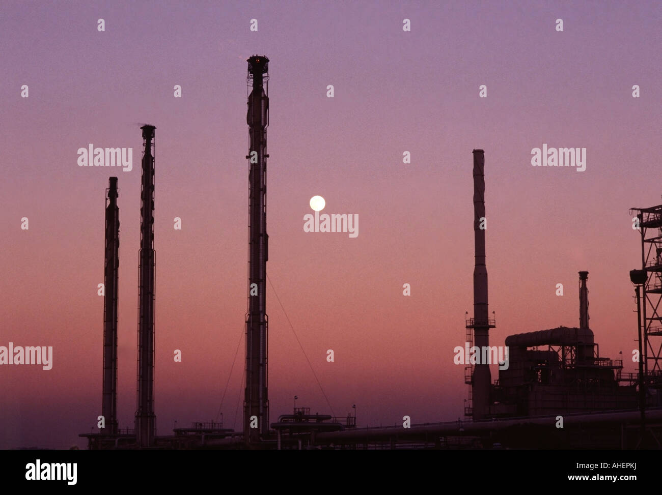 Moon rising over the Pipes and Tanks of a crude oil refinery in ...