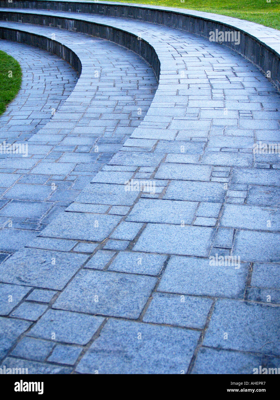 Long curving stone steps leading from one grass plateau to another at ...