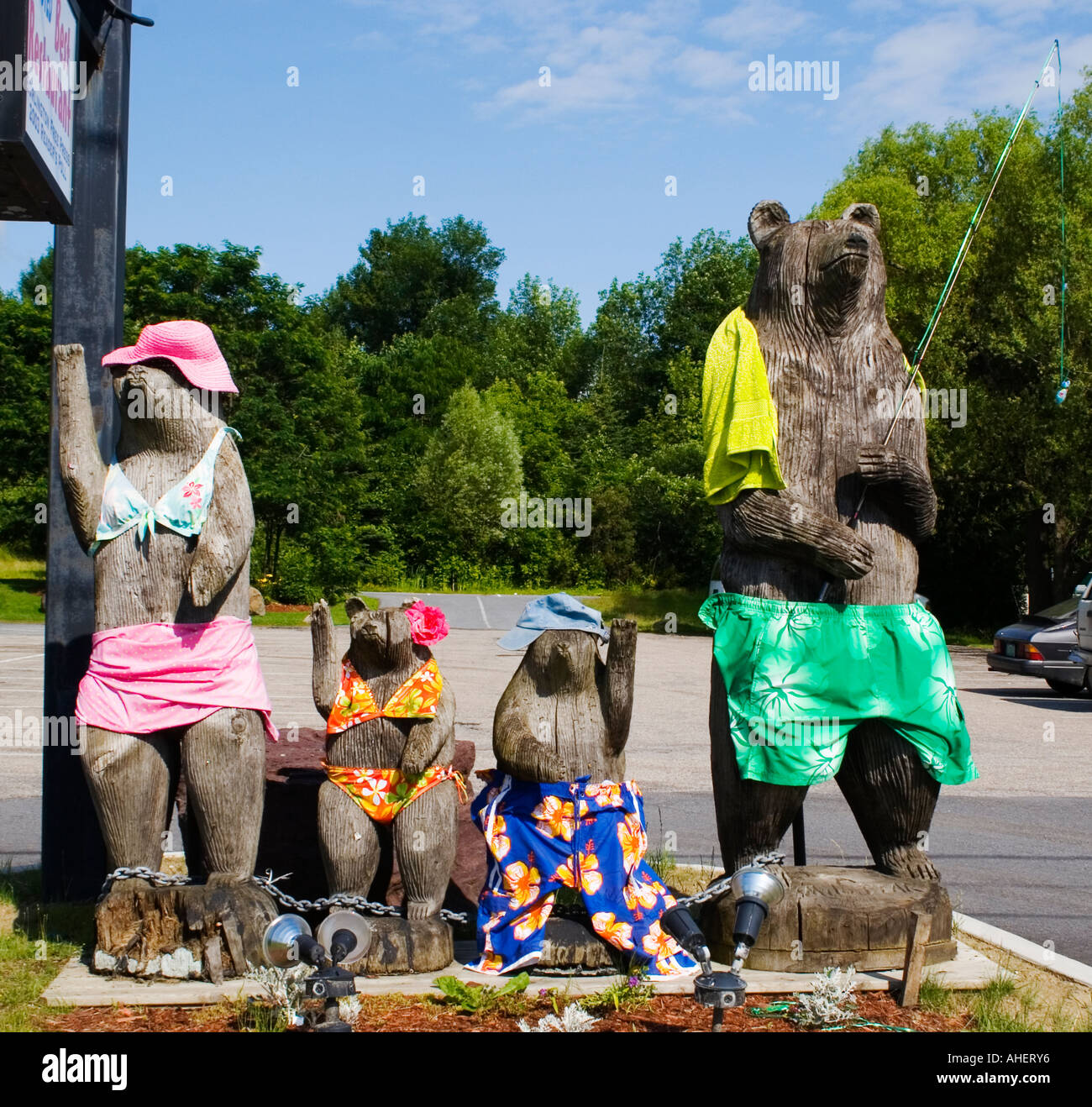 Family of wood carved bears posing as tourists in bathing suits outside ...