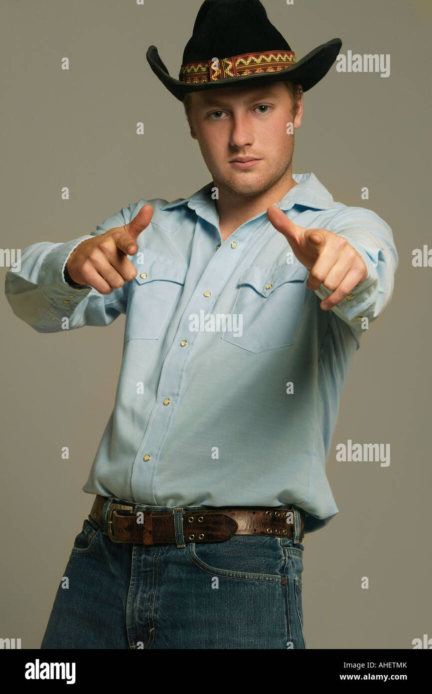 Cowboy pointing with two hands ahead Stock Photo - Alamy