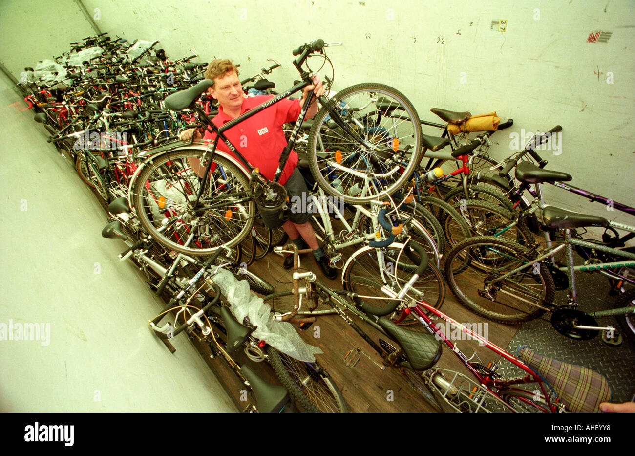 Man loading many cycles into a lorry at the end of the London to ...