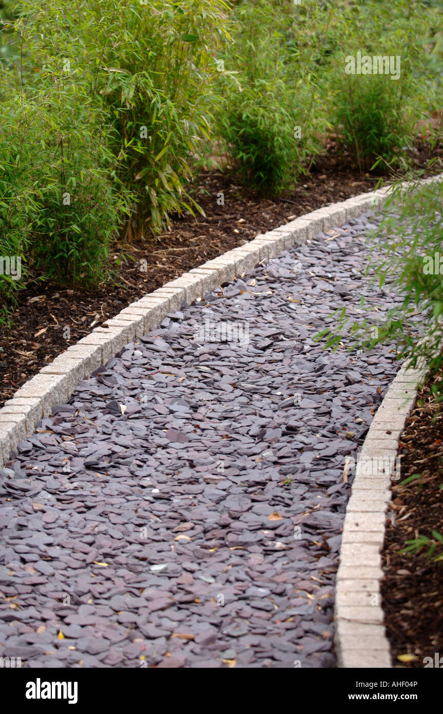 A PATH LAYED WITH SLATE SHARDS AND EDGED WITH GRANITE COBBLESTONES ...