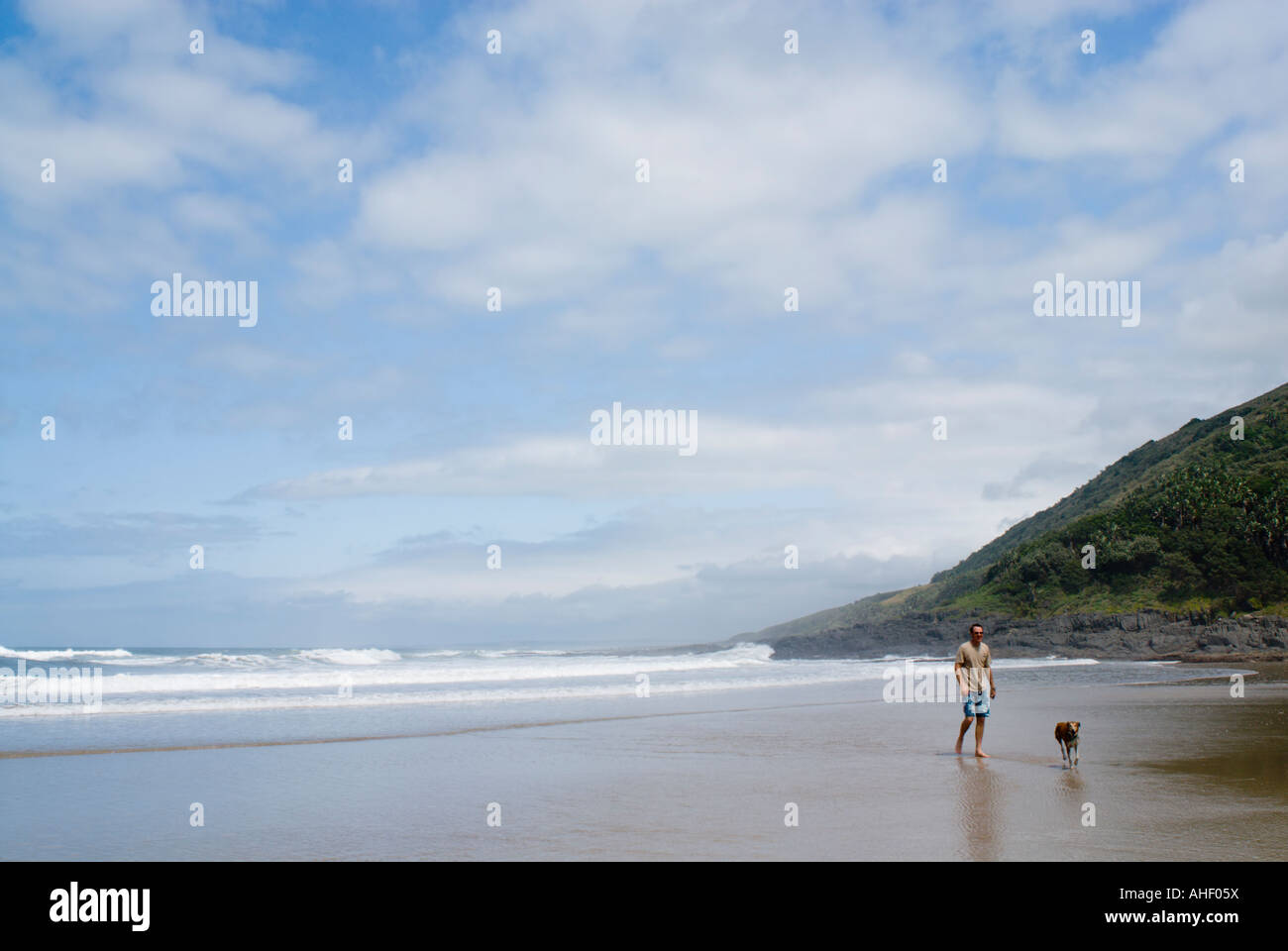 Male beach goer with dog at the seaside in Haga Haga, Eastern Cape ...