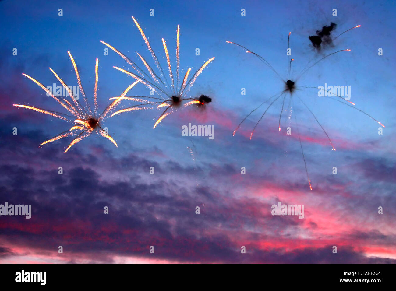 fireworks against a sunset sky Stock Photo - Alamy