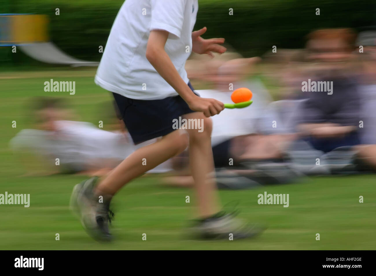 schoolboy competing in an egg and spoon race on school sports day Stock ...