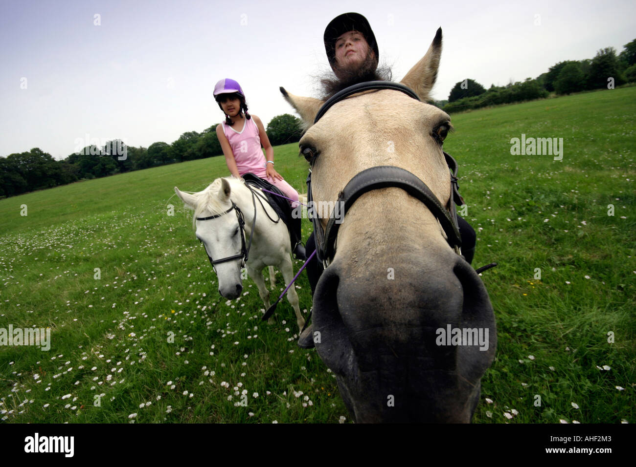 Two girls in ponies hi-res stock photography and images - Alamy