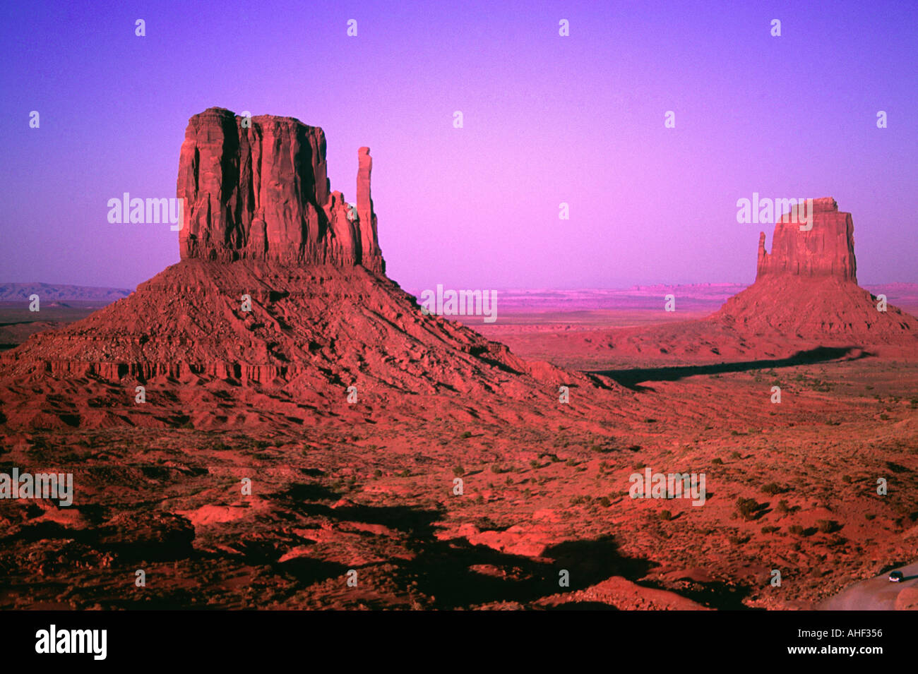 The two most famous monoliths in Monument Valley tower over the ...