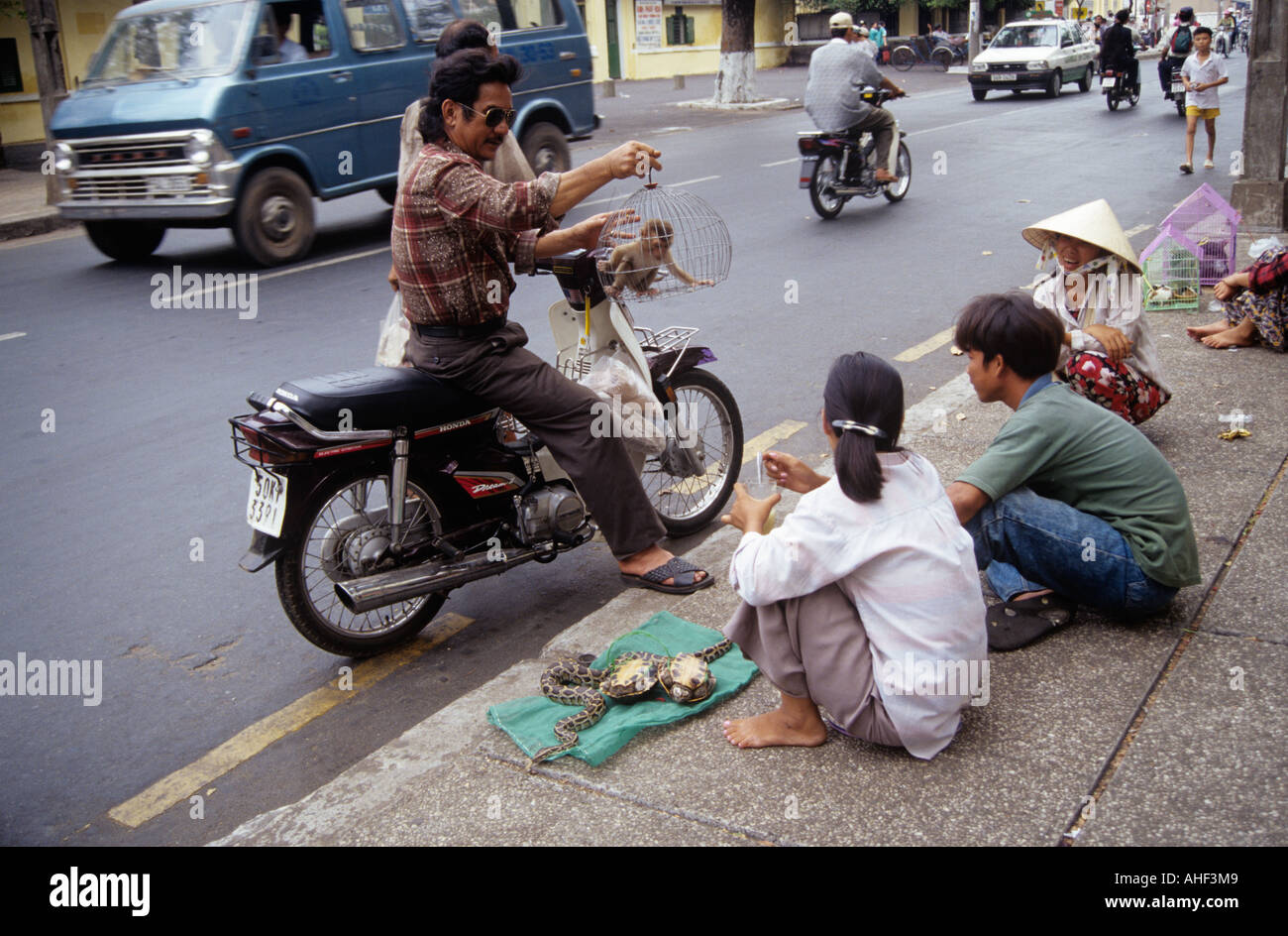 Monkey and snakes being sold in Ho Chi Minh City Stock Photo - Alamy