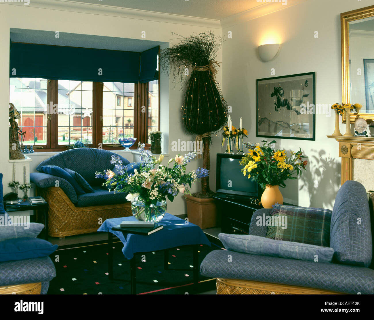 Twig decoration in corner of nineties living room with blue cushions on ...