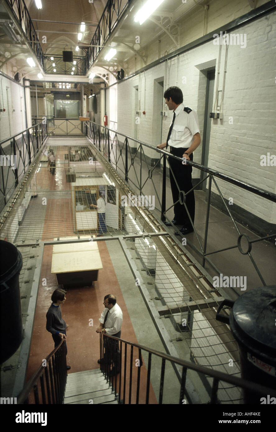 Interior of a prison with guards and prisoners Stock Photo - Alamy