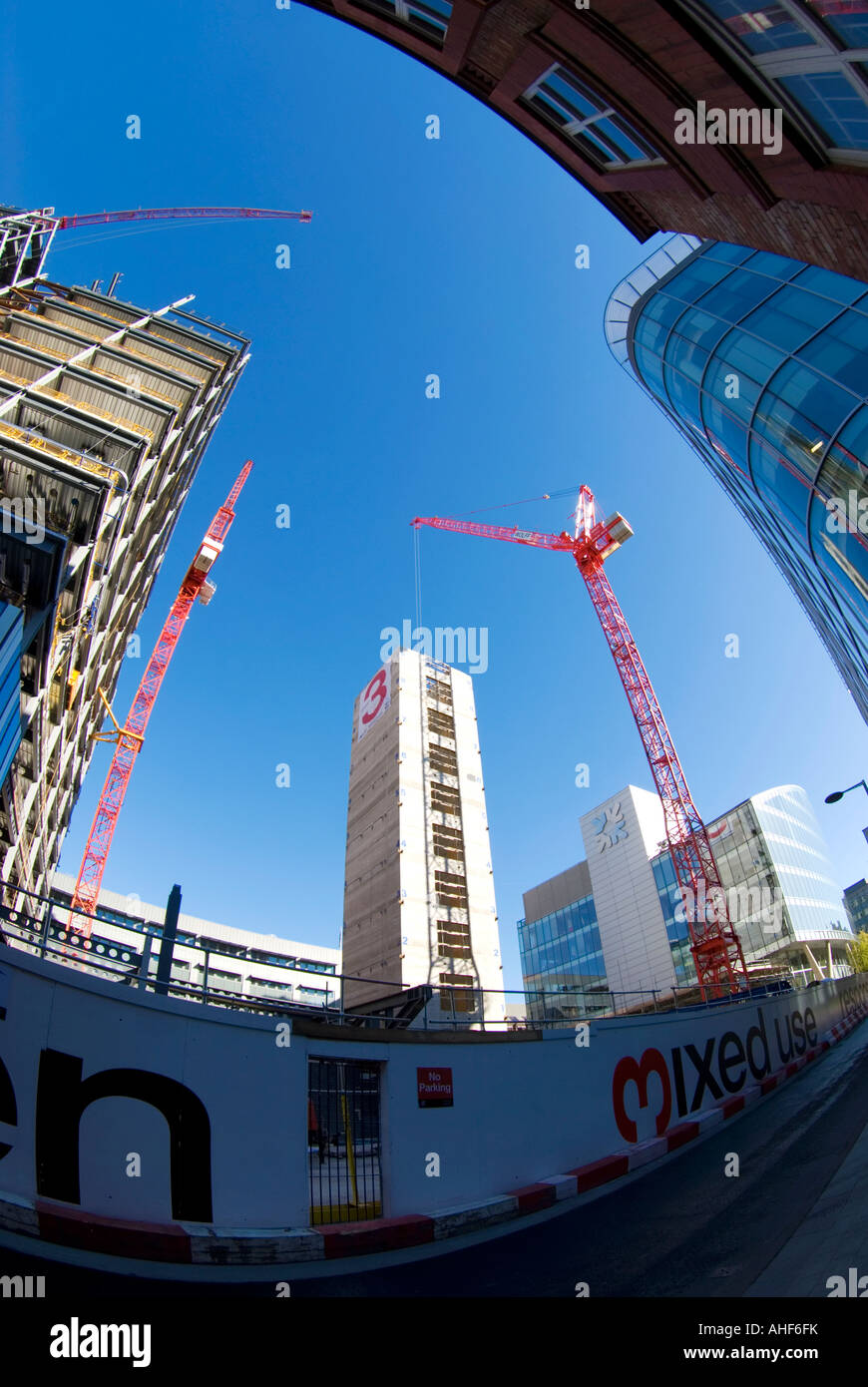Red tower crane and buildings under construction in Manchester city ...