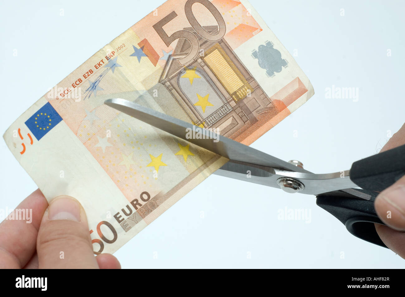 To cut a banknote Stock Photo - Alamy