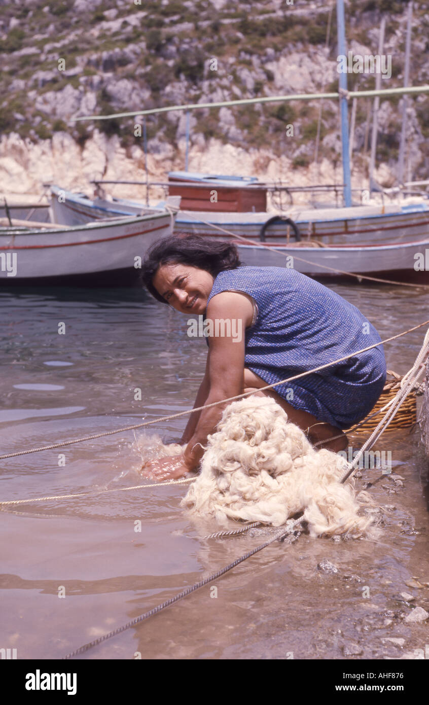 Greek peasant woman washes raw wool in sea Gaios Paxos Greece Stock ...