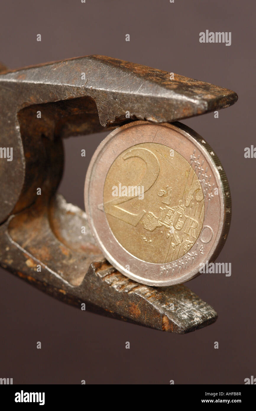 Euro coin money trapped in pressure squeeze of plier tool Stock Photo ...