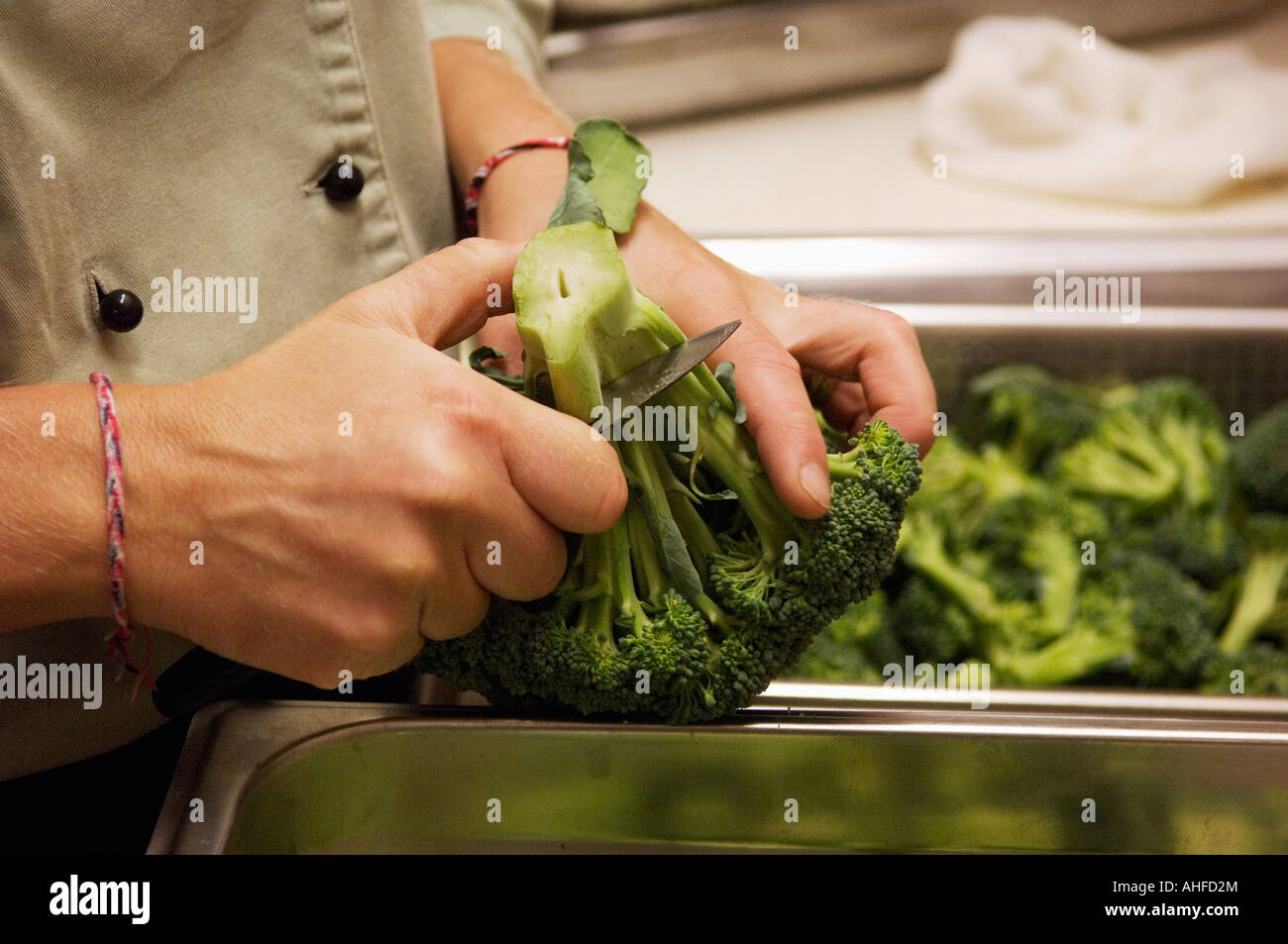 Trimming broccoli in a restaurant kitchen Stock Photo - Alamy