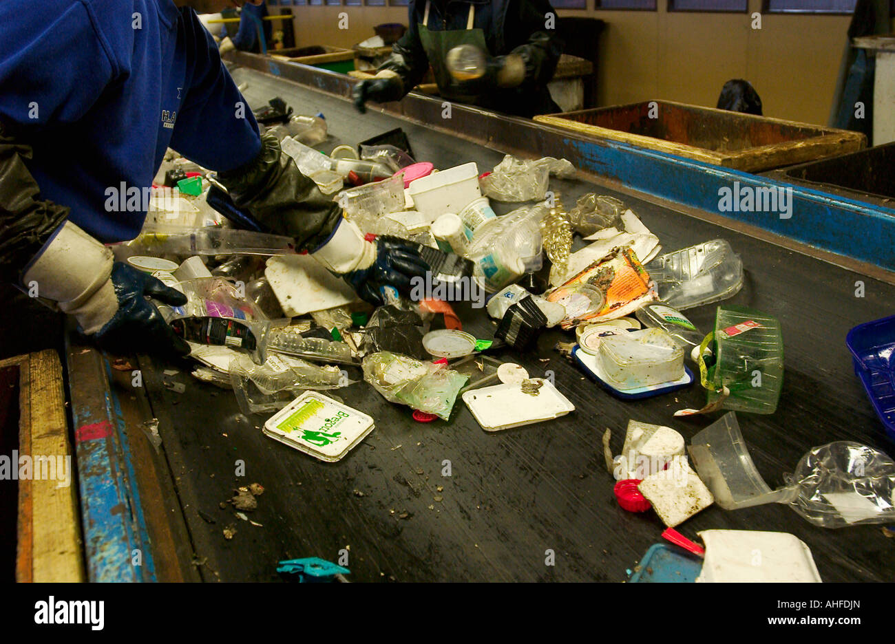 Sorting garbage on a moving conveyor belt Stock Photo - Alamy