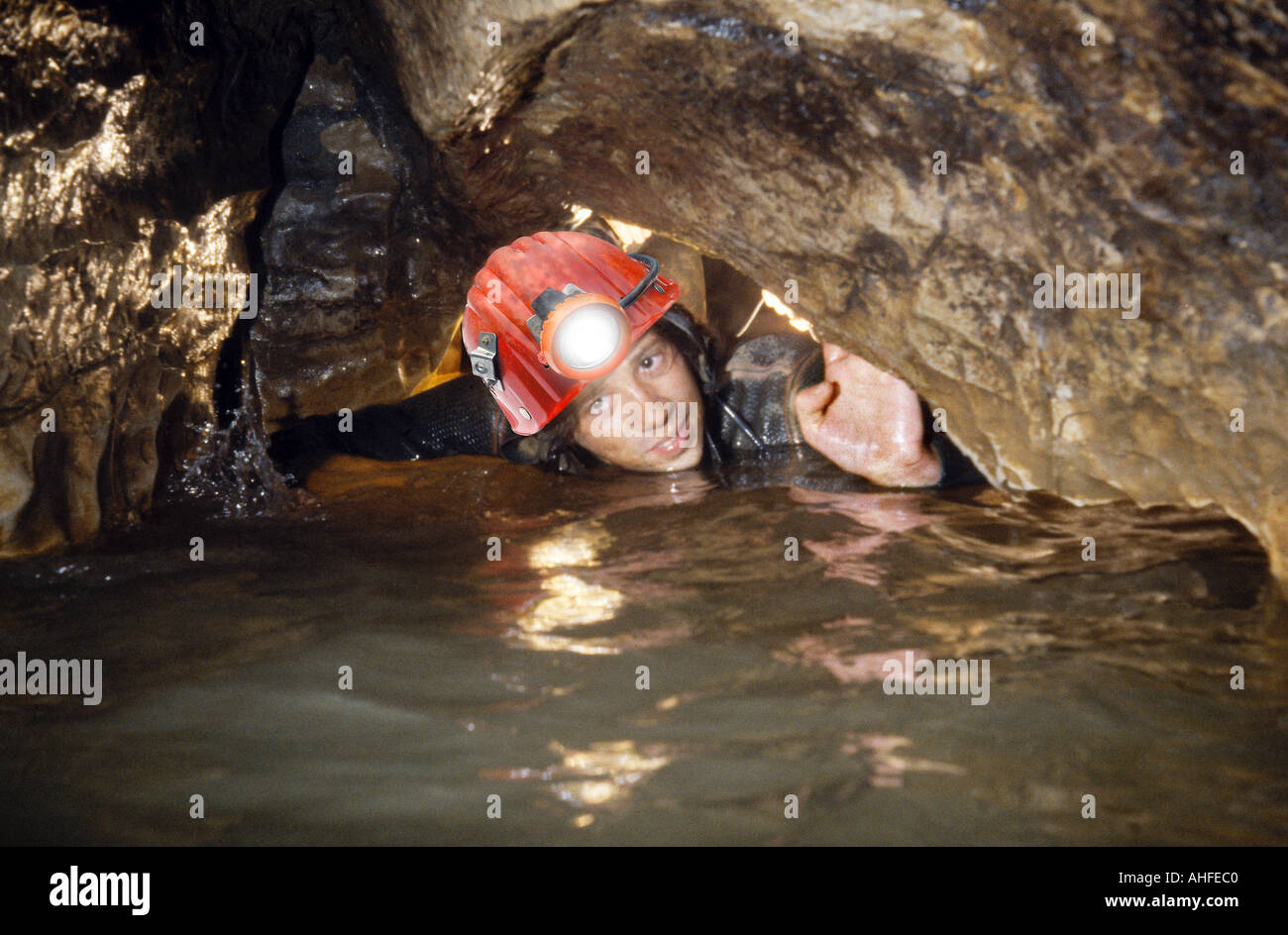 Caver swimming in deep water in cave Wales UK Stock Photo - Alamy