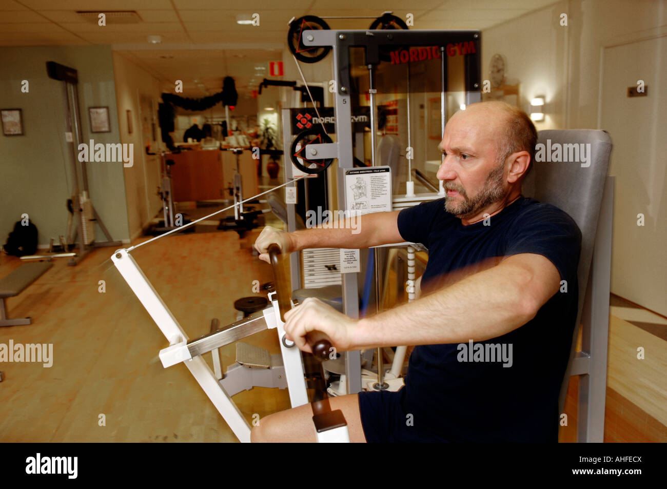 Man using weightlifting-machine in a gym Stock Photo - Alamy