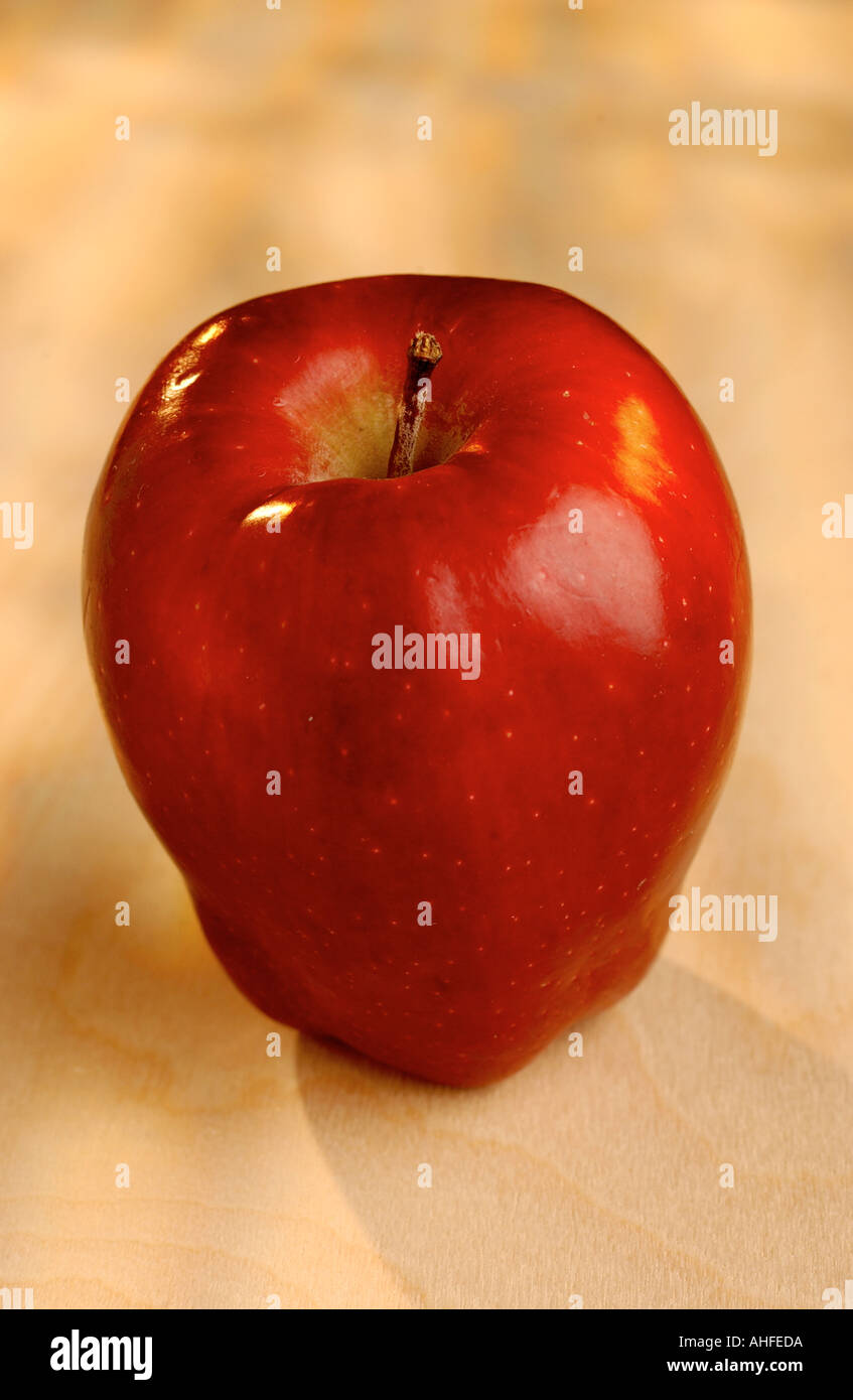 Vertical color image of an apple sitting on a wood countertop Stock ...