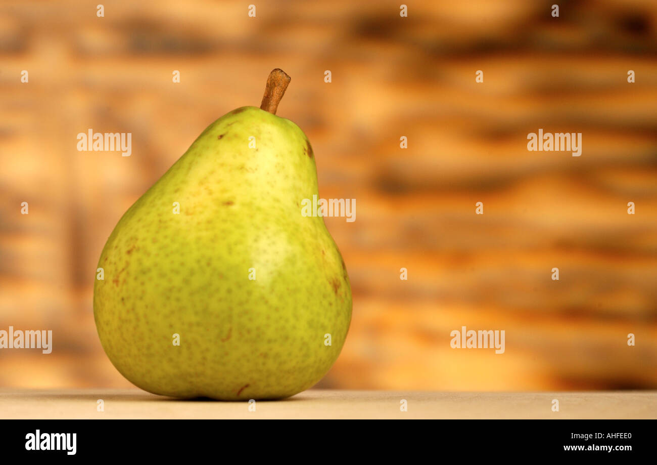 Horizontal color image of a pear sitting on a wood countertop Stock ...