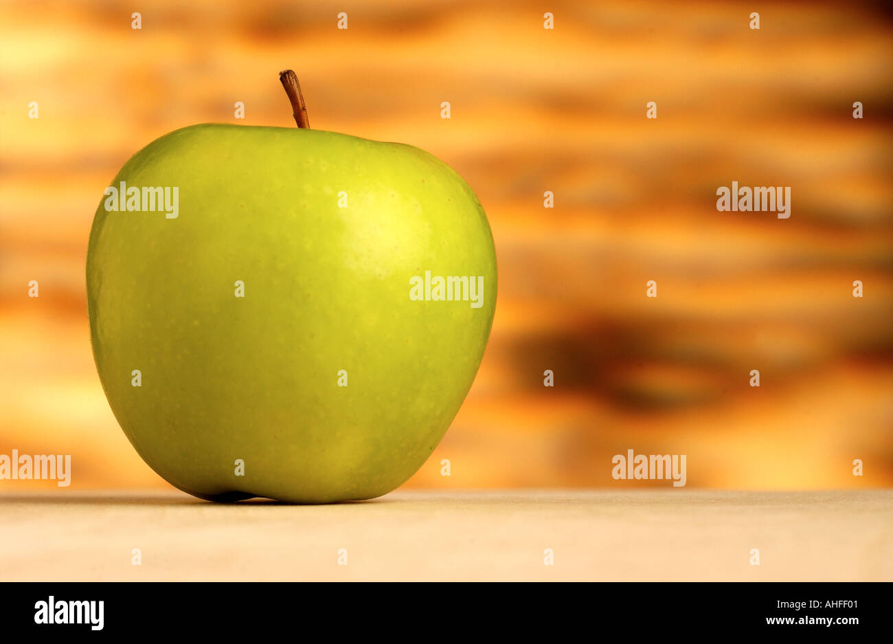 Horizontal color image of a green apple sitting on a table Stock Photo ...