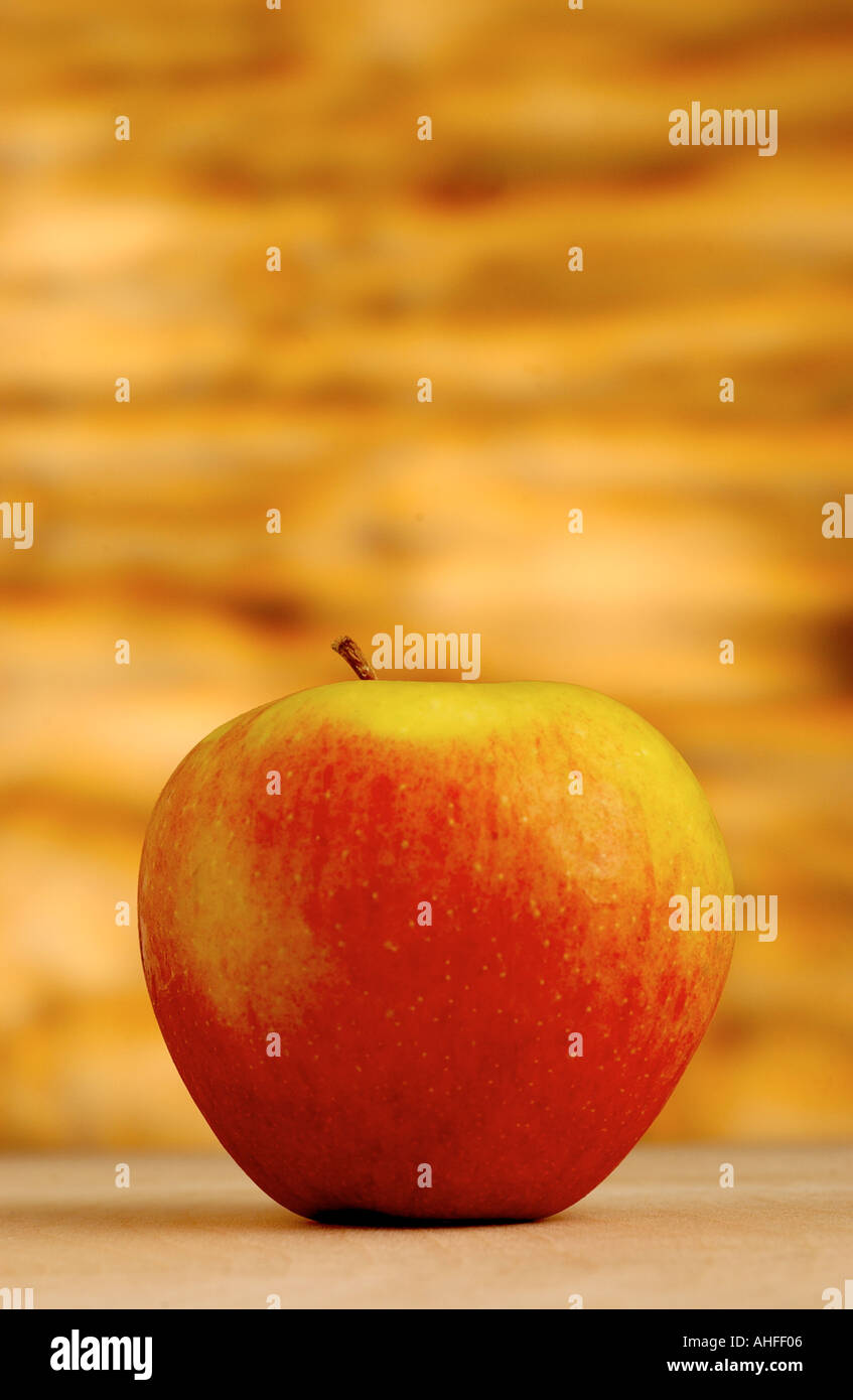 Vertical color image of a red apple sitting on a table Stock Photo - Alamy