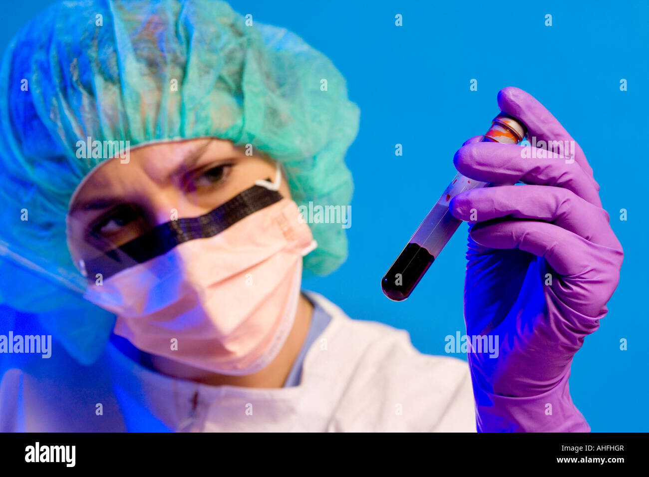 Female lab tech holding single test tube specimen in gloved hand Stock ...