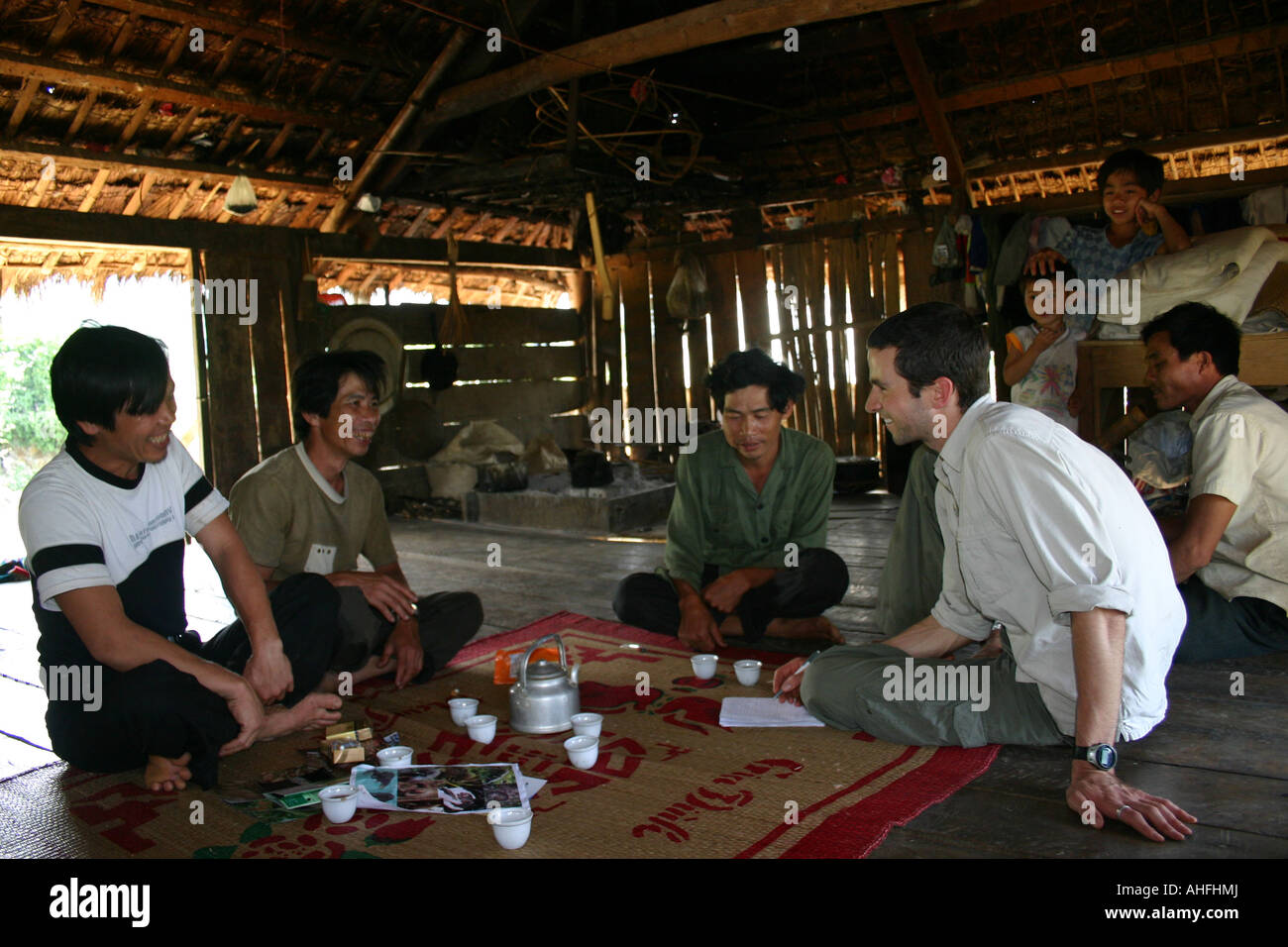 Caucasian man interviewing Vietnamese hunters Stock Photo - Alamy