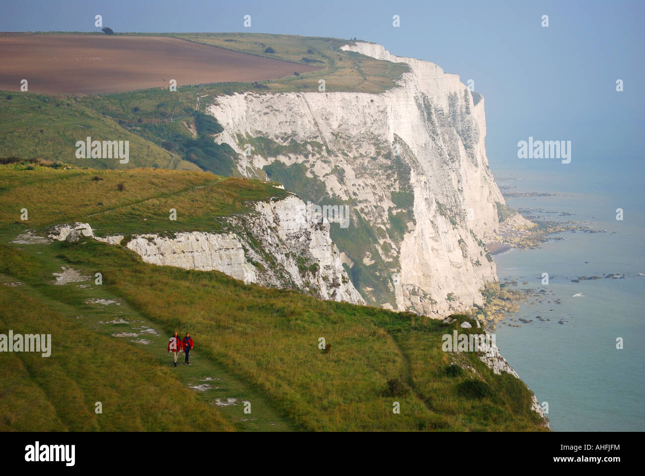 Couple walking on cliff path, The White Cliffs, Dover, Kent, England ...