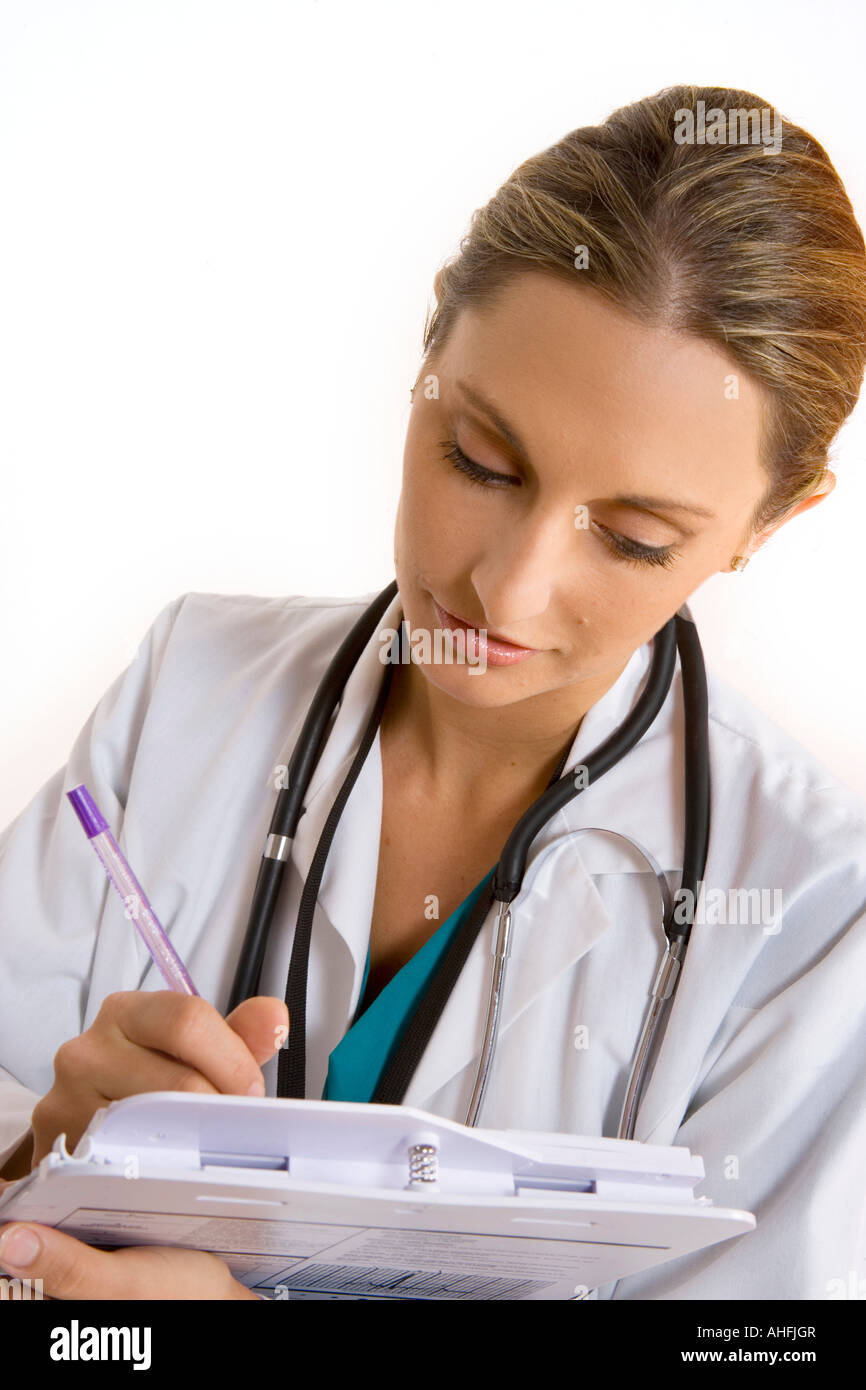 Female physician making notes on patient chart Stock Photo - Alamy