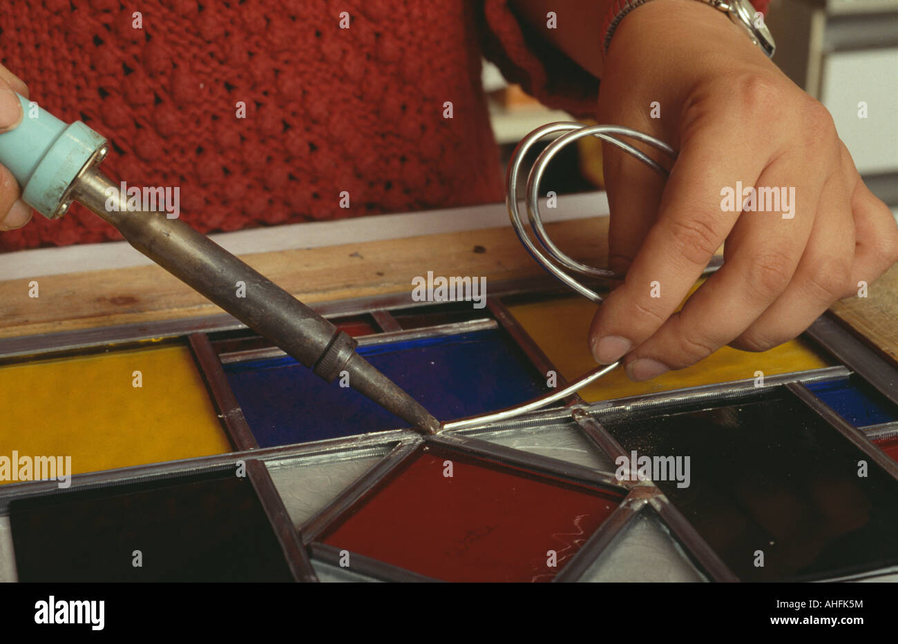 Close up of hands with glass and stained glass tools Stock Photo - Alamy