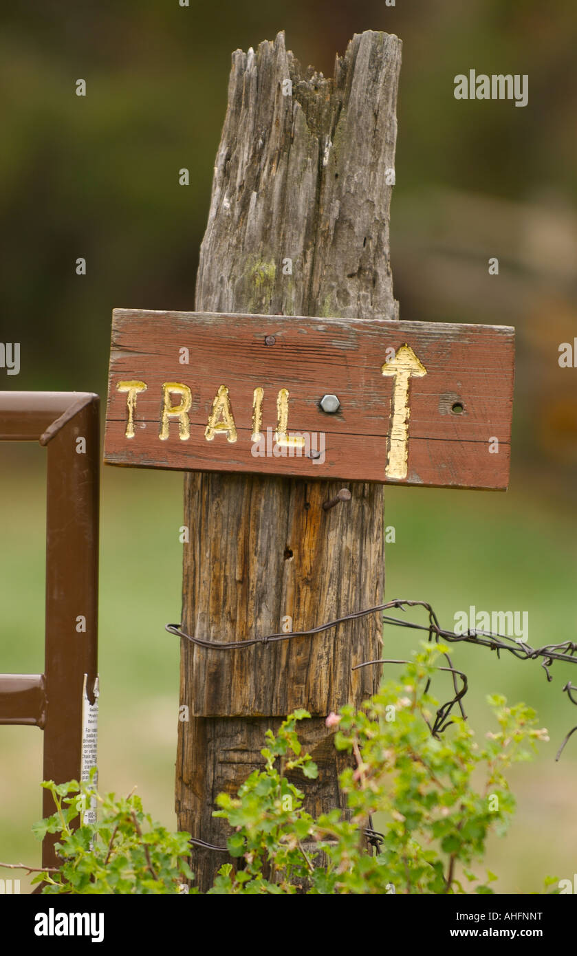 Wooden trail sign with an arrow on a wooden fence post Stock Photo - Alamy