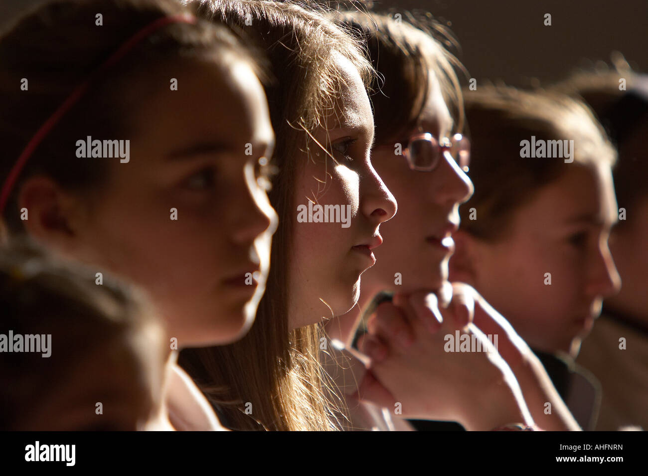 Kneeling Catholic school children praying during Mass Stock Photo - Alamy