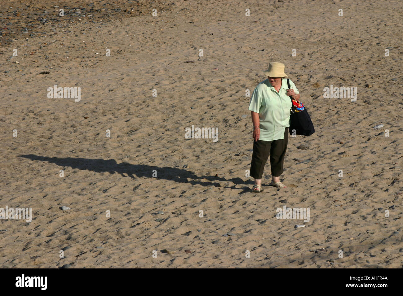 Woman throwing a shadow on the sand hi-res stock photography and images ...