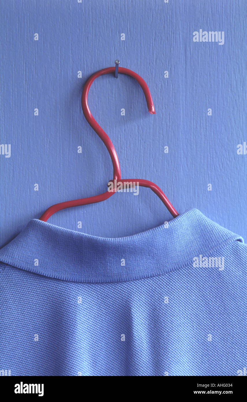 Red Hanger With Blue Shirt Hanging On Blue Wall Stock Photo - Alamy
