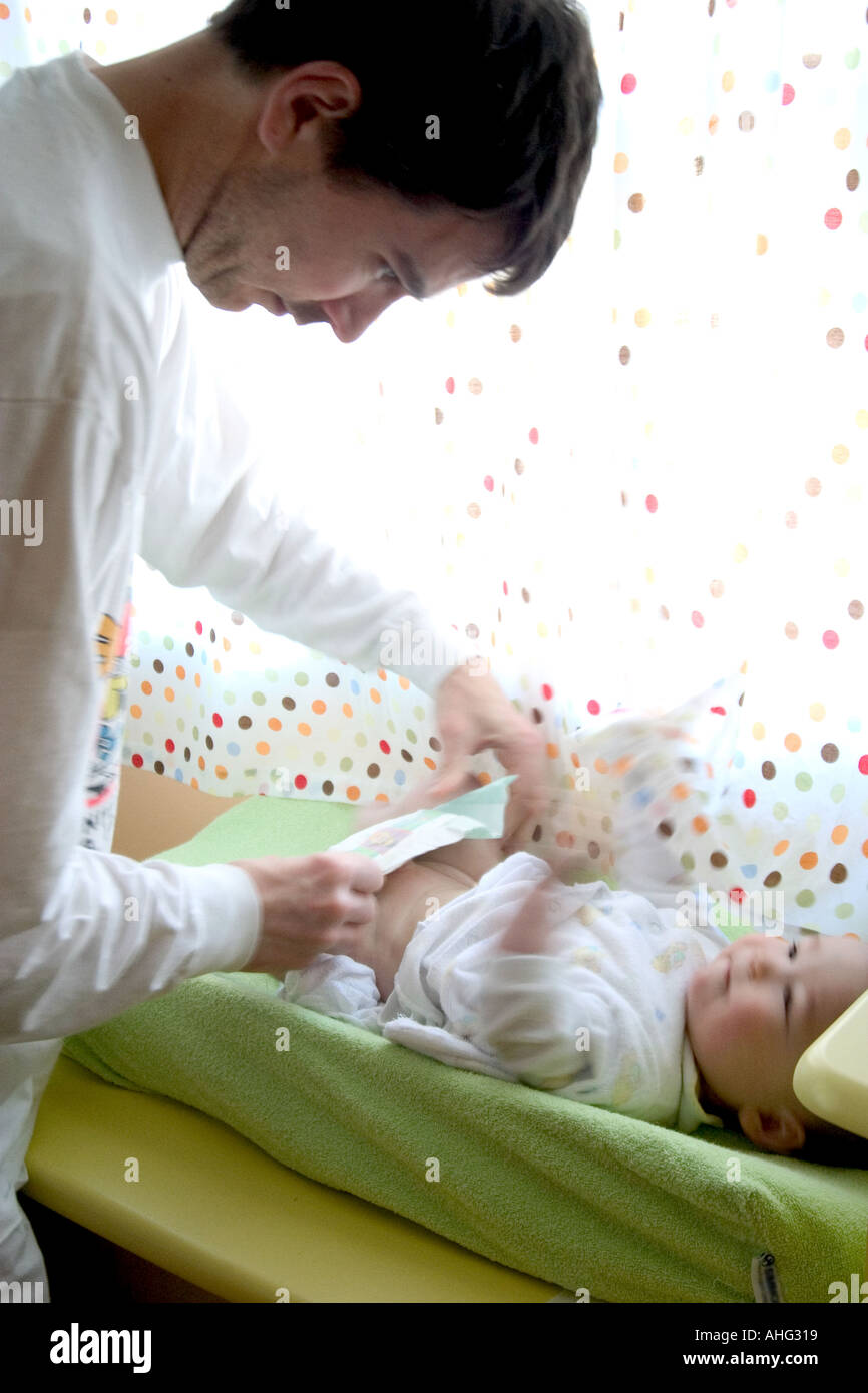 Father changing baby s diaper Stock Photo - Alamy