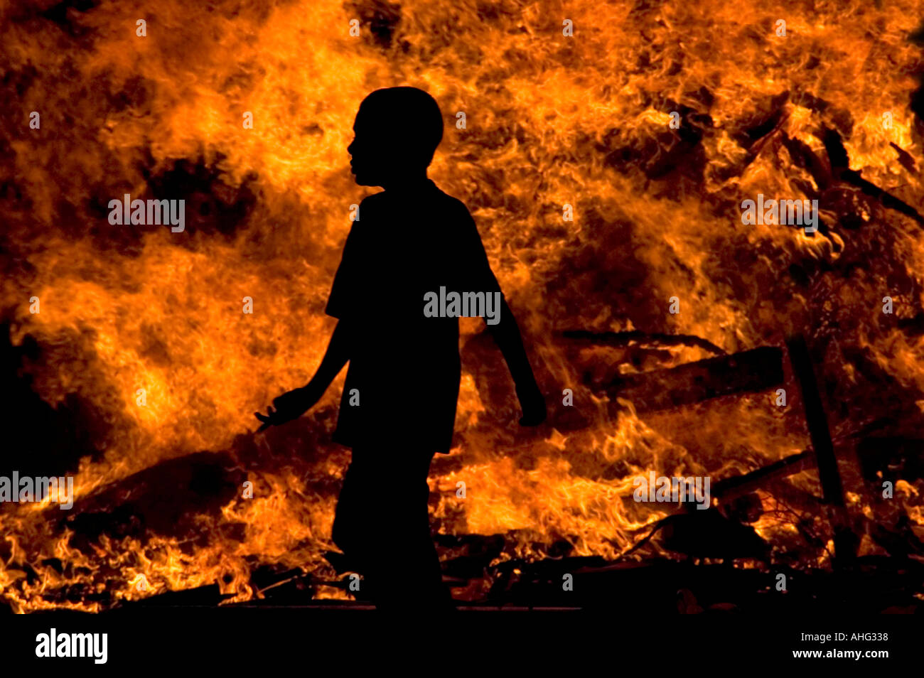 Boy by a raging fire Stock Photo - Alamy