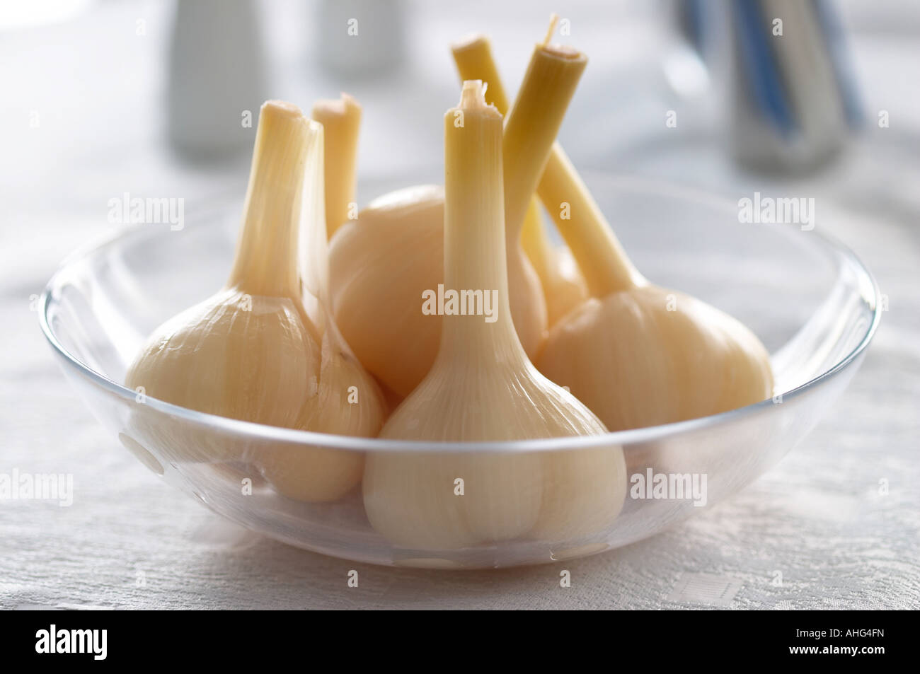 Marinaded (pickled) garlic in glass cup macro 3 Stock Photo - Alamy