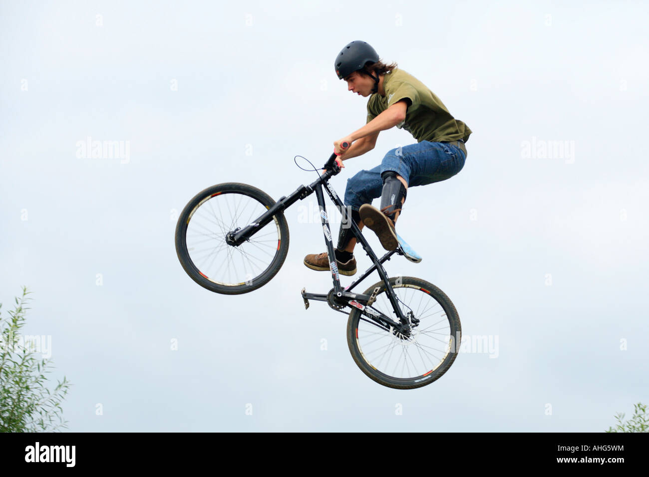 young boy jumping with his bike Stock Photo - Alamy