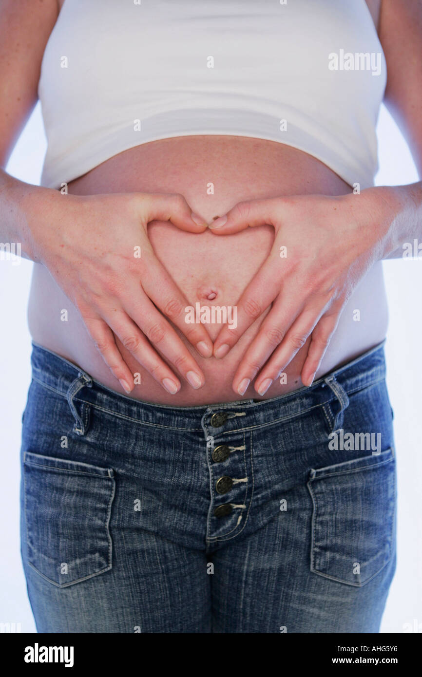pregnant woman forming a heart on her belly Stock Photo - Alamy