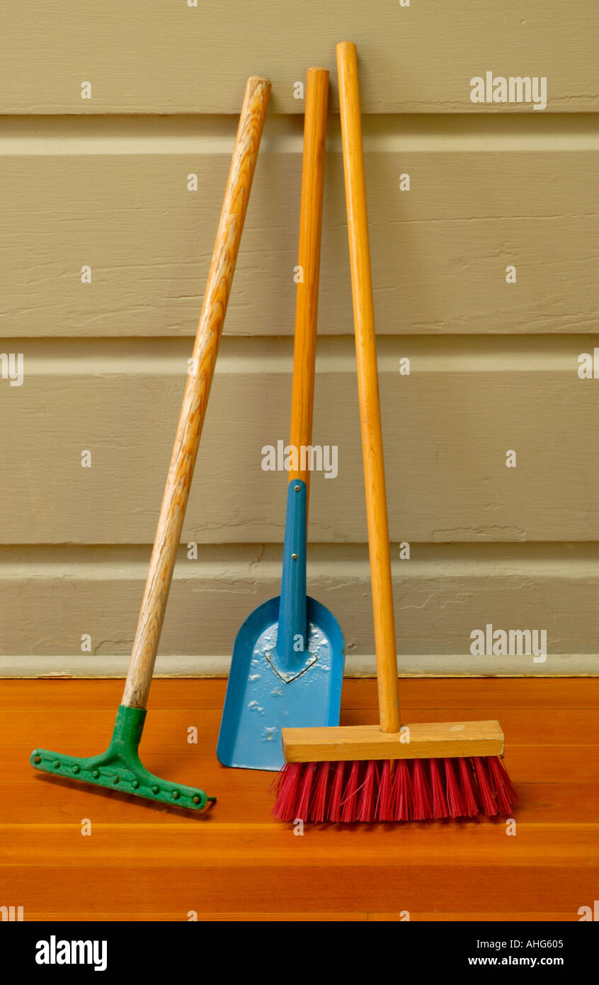 rake shovel and broom on porch Stock Photo - Alamy