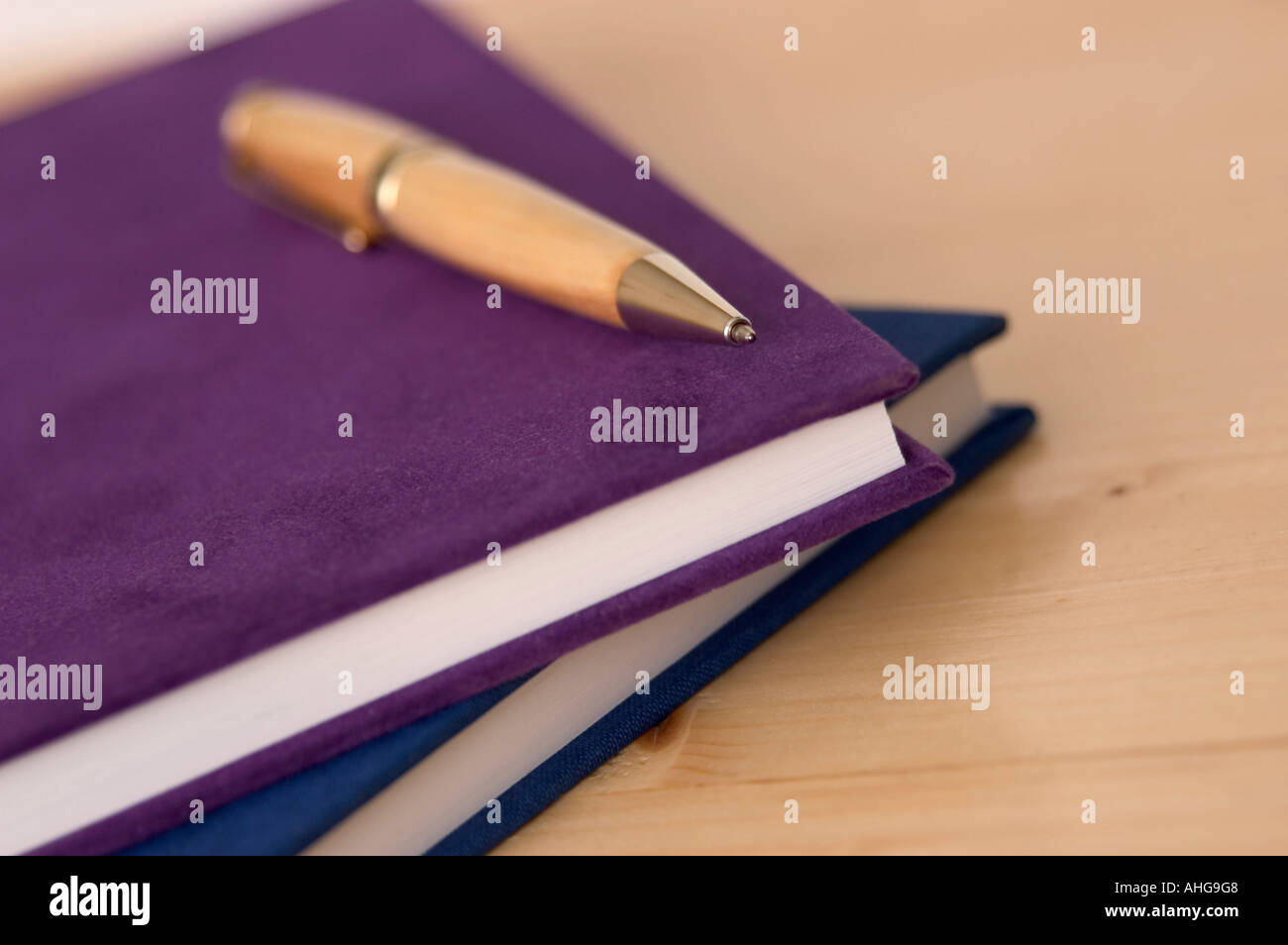 Still life of pen laying on writing journal on table USA Stock Photo ...