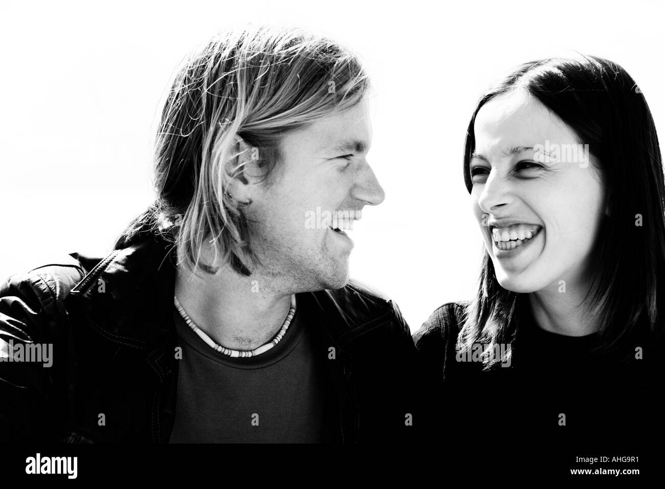 Strong backlighted photo Young couple having fun together Stock Photo ...