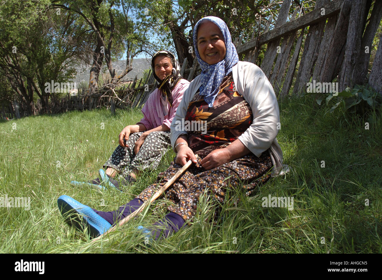 Two Turkish women sitting in a field in Bezirgan a small village in ...