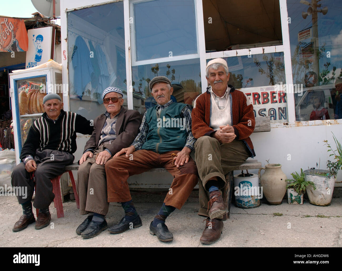 Turkish men sitting about by village barbers shop Stock Photo - Alamy